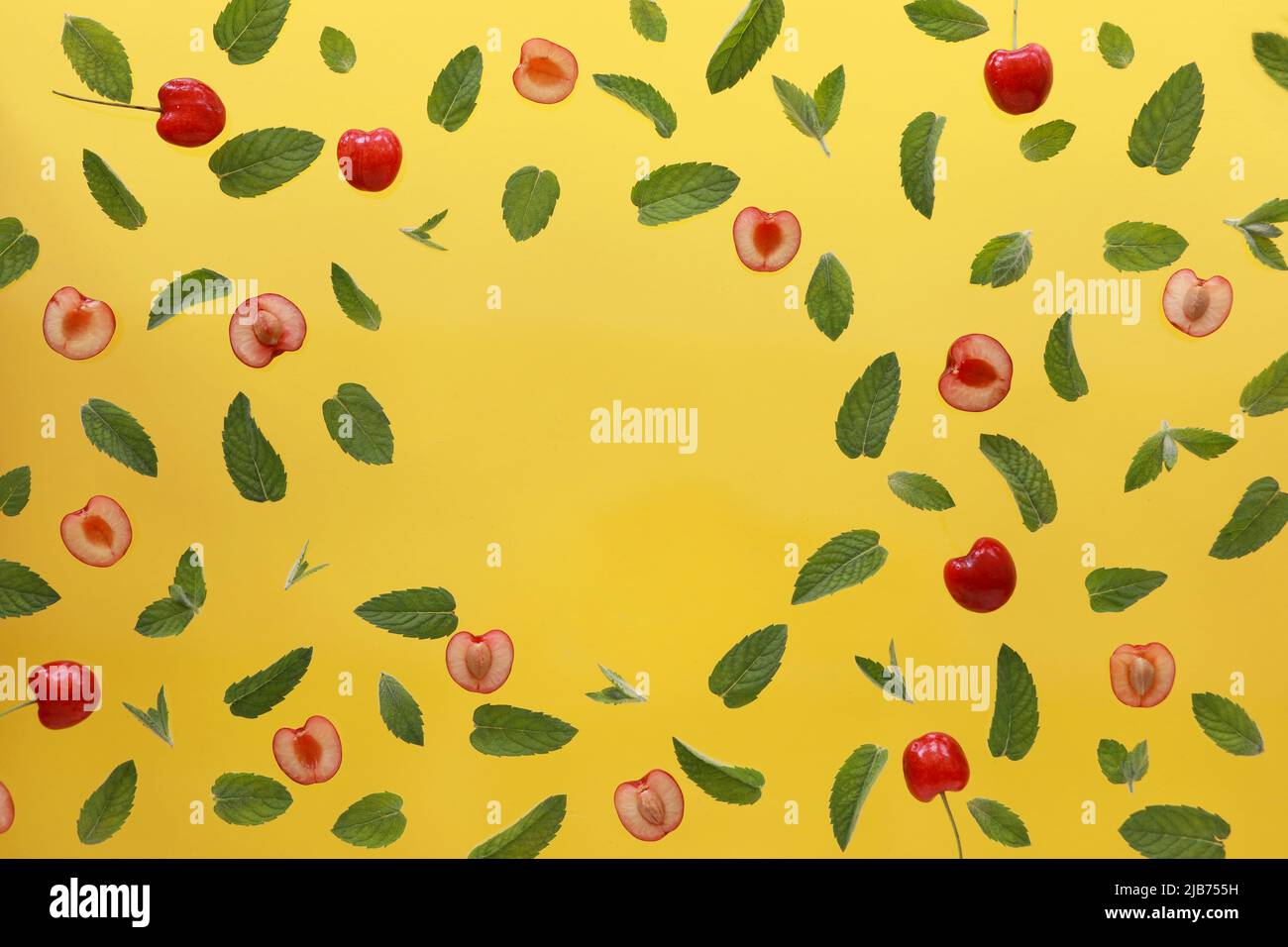 Summer background, frame with fresh cherry fruits and mint on yellow ...
