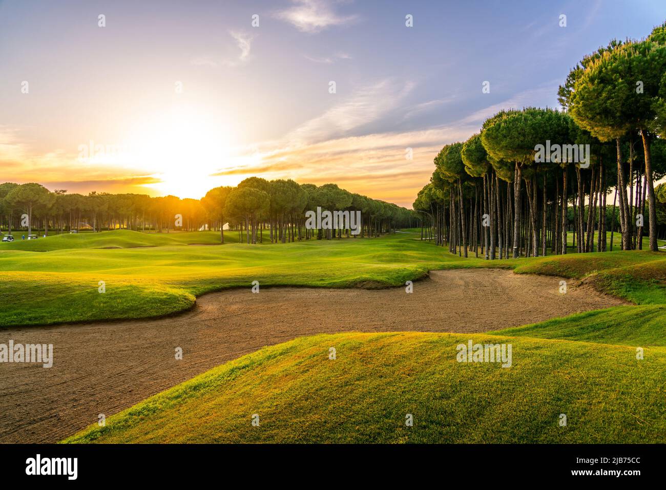 Golf course at sunset with beautiful sky and sand trap. Scenic ...