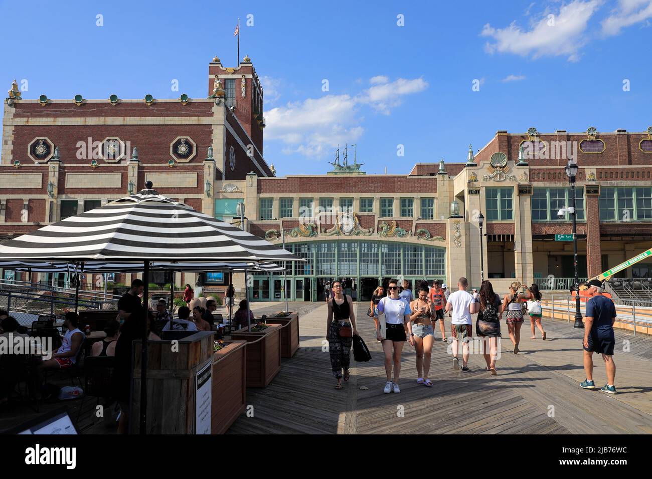 Visitors on Asbury Park Beach boardwalk with Convention Hall in the background.Asbury Park.New ...