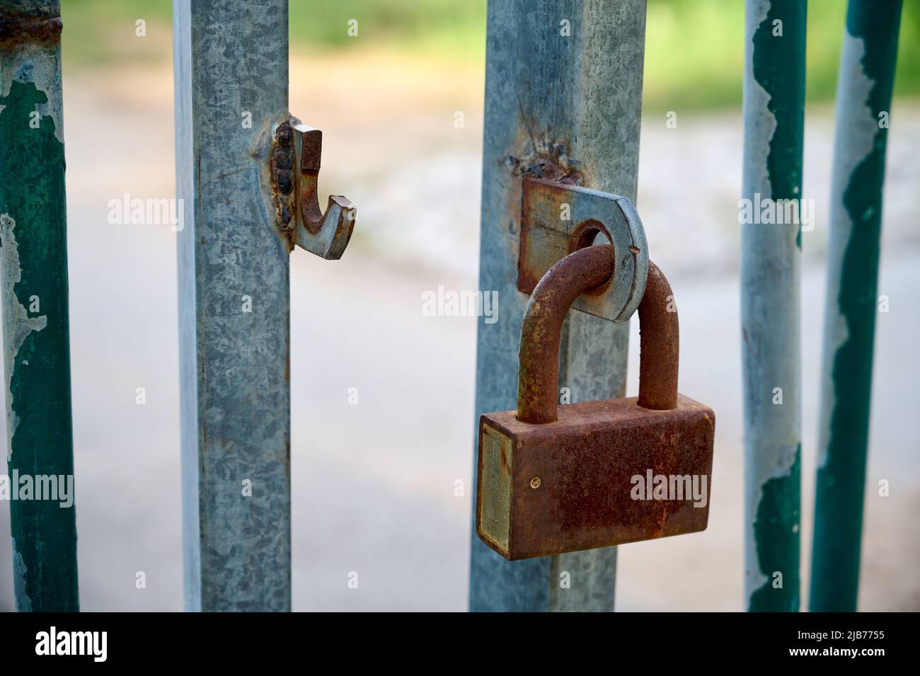 The gates are broken open and on one leaf there is a closed padlock ...