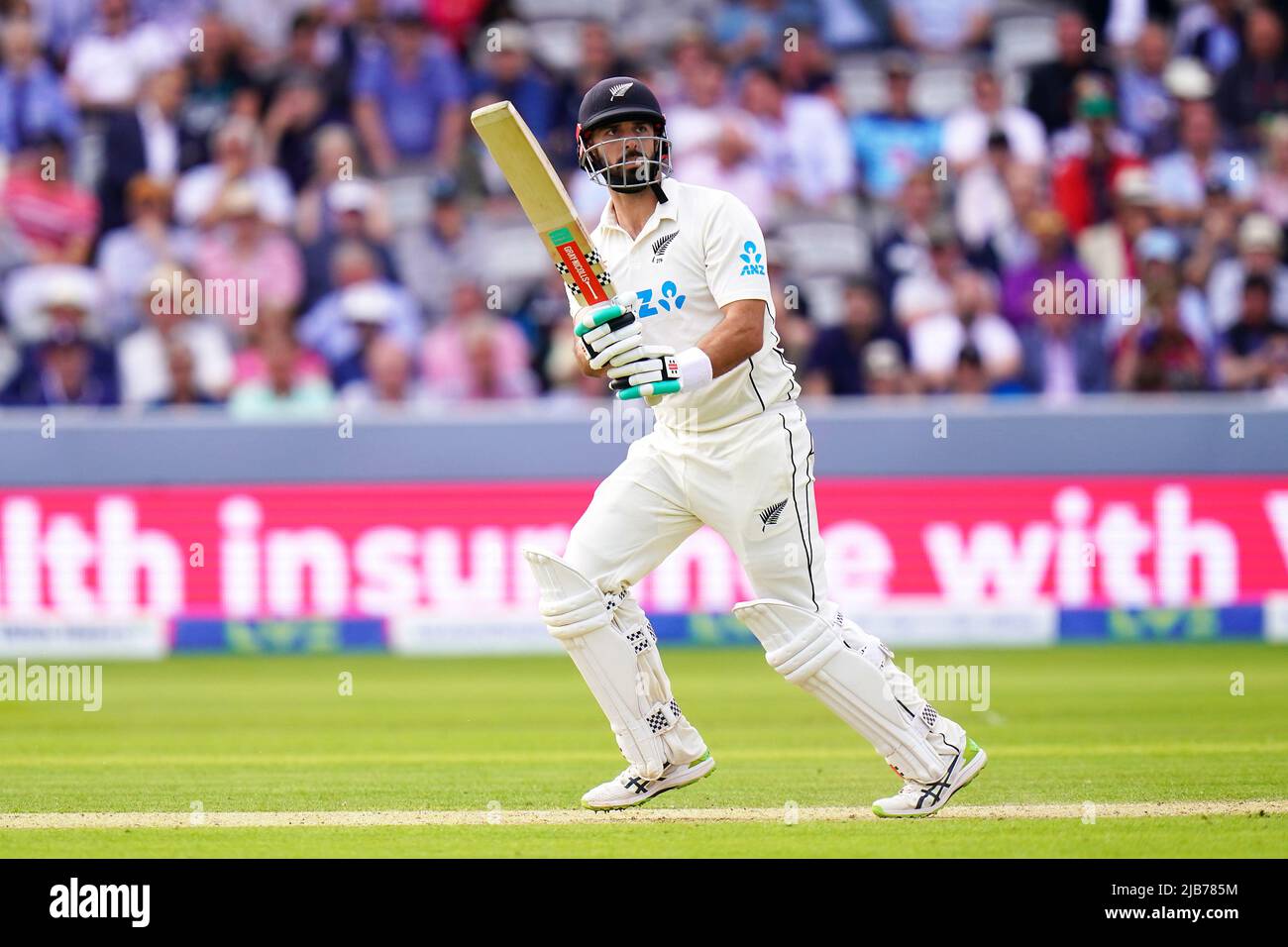 New Zealand's Daryl Mitchell watches a ball as it hits the boundary ...