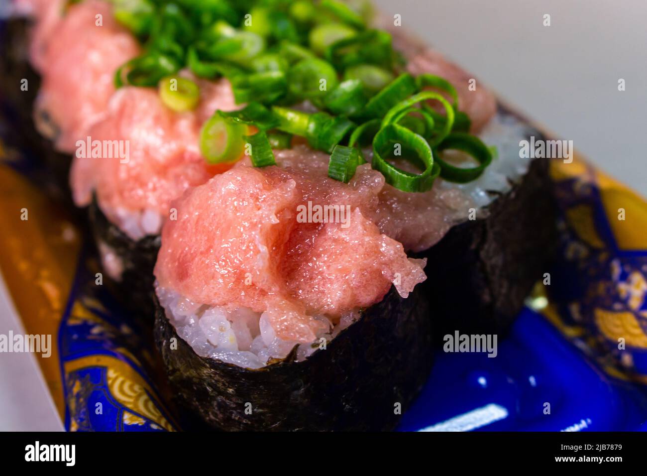 Closeup takeout Negi Toro Sushi Rolls in a supermarket food container ...