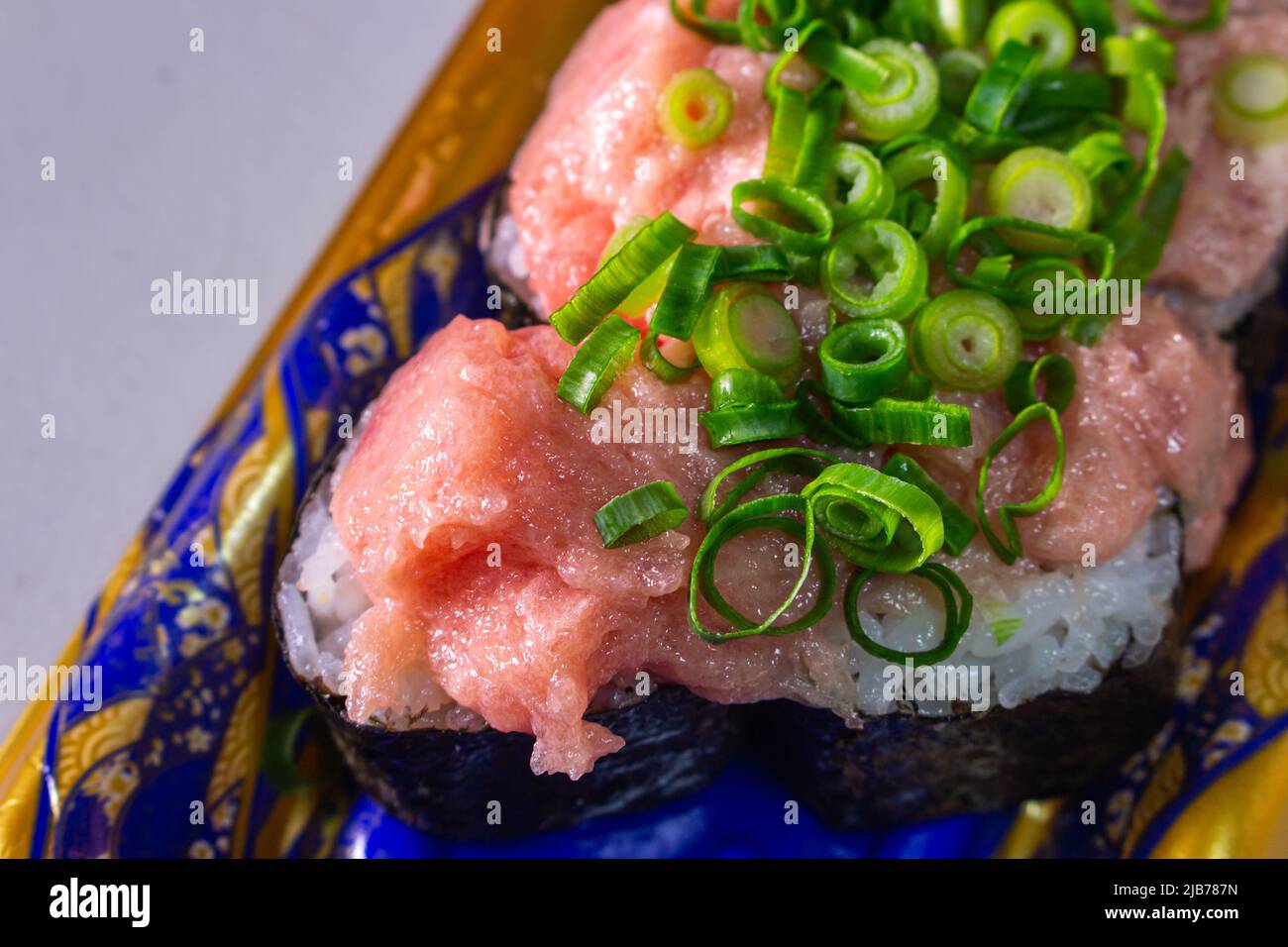 Closeup takeout Negi Toro Sushi Rolls in a supermarket food container ...