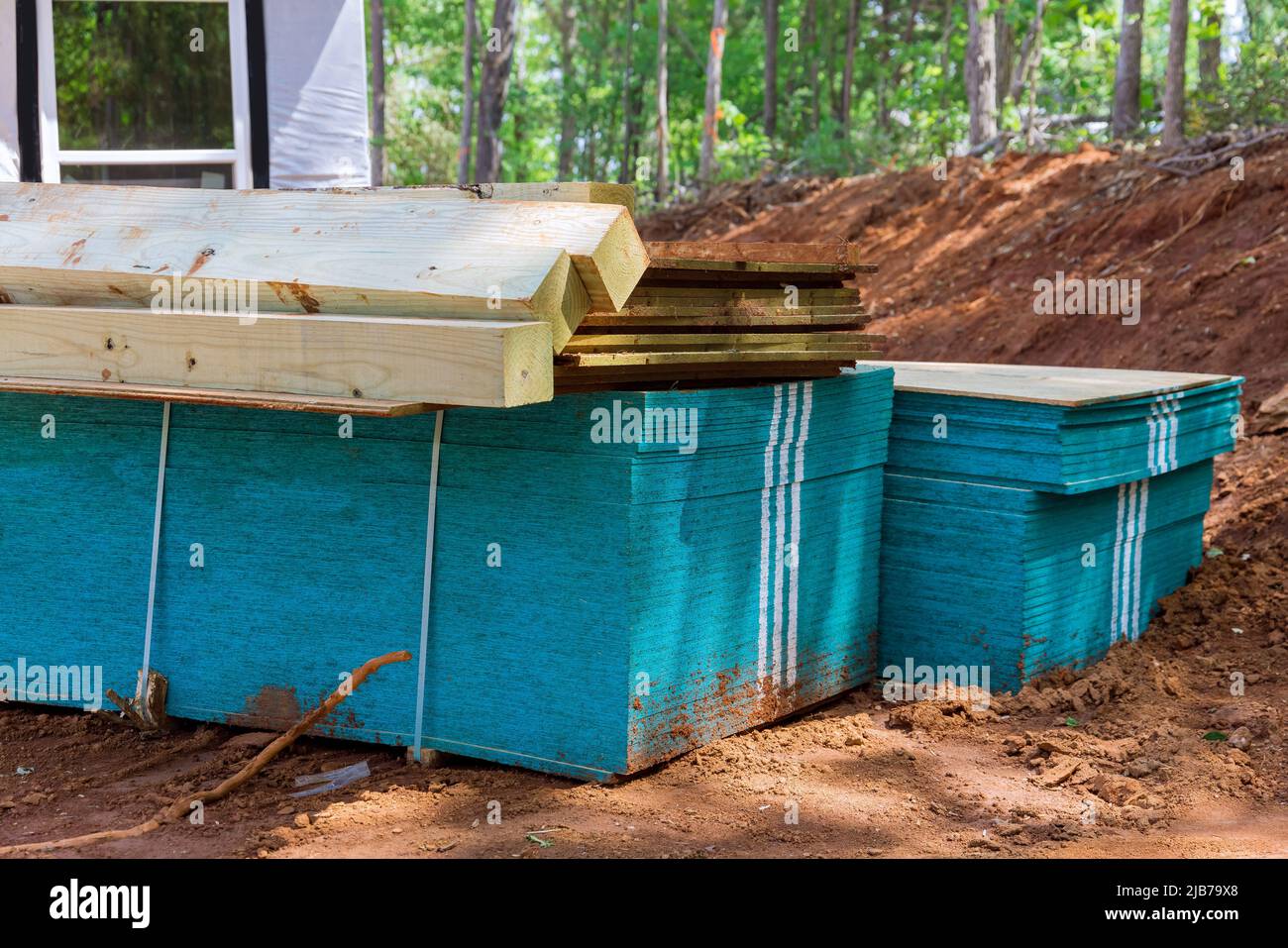 Stacker wooden material boards and beams for new house on of under ...