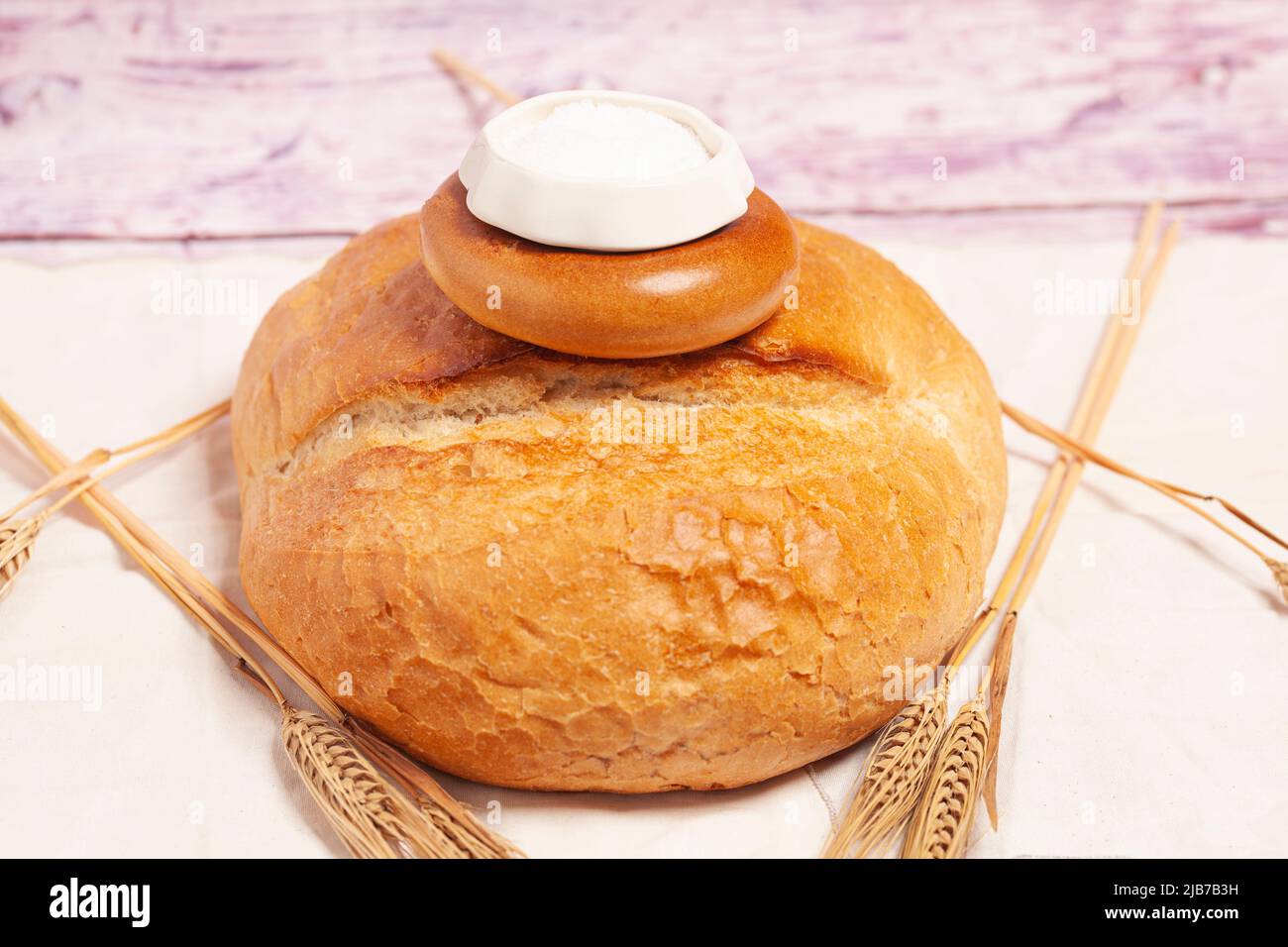 Bread with salt is a traditional symbol of hospitality. Round wheat ...