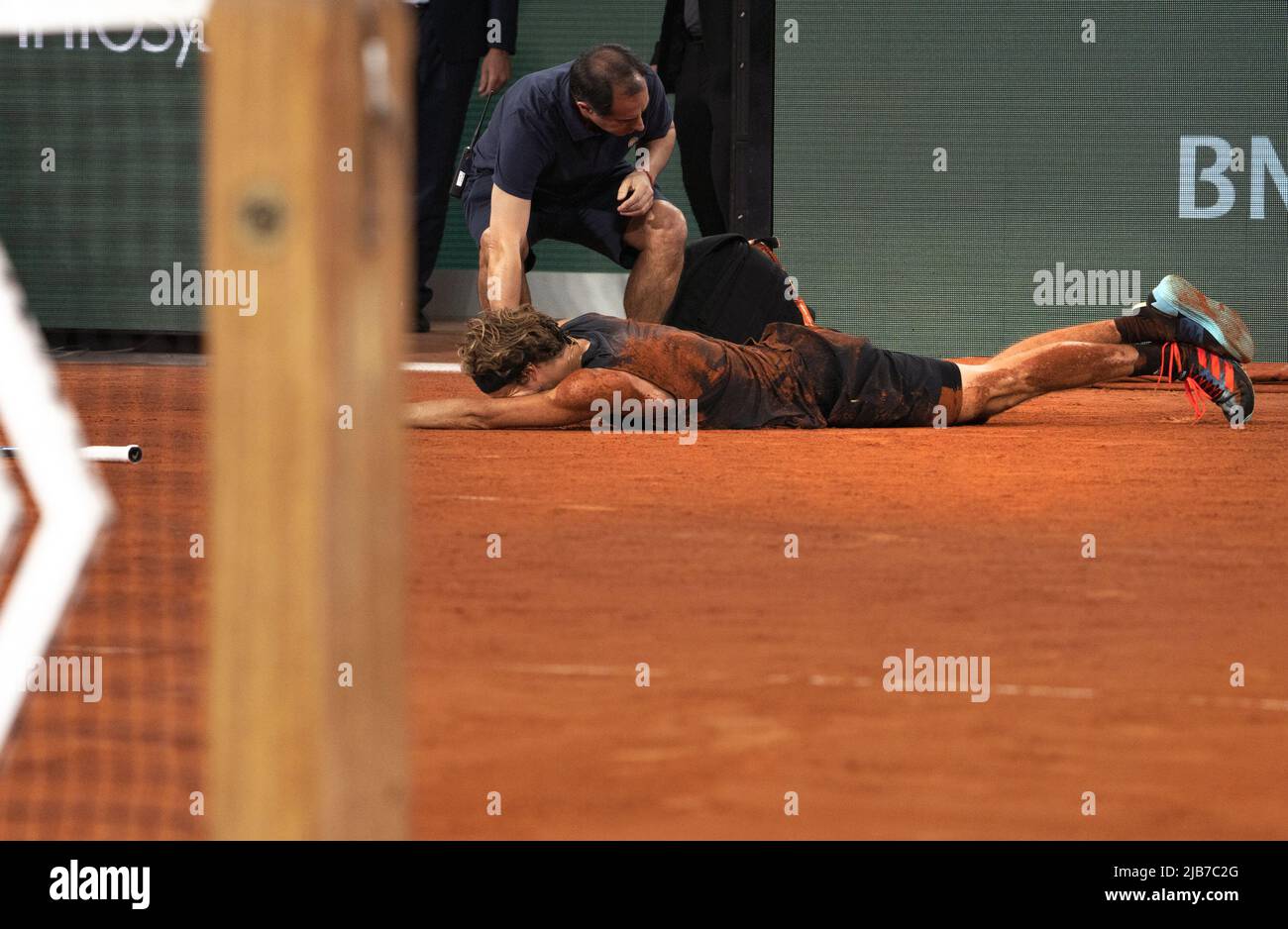 Paris, France. 03rd June, 2022. Third seeded Alexander Zverev of Germany lies in pain on the ...