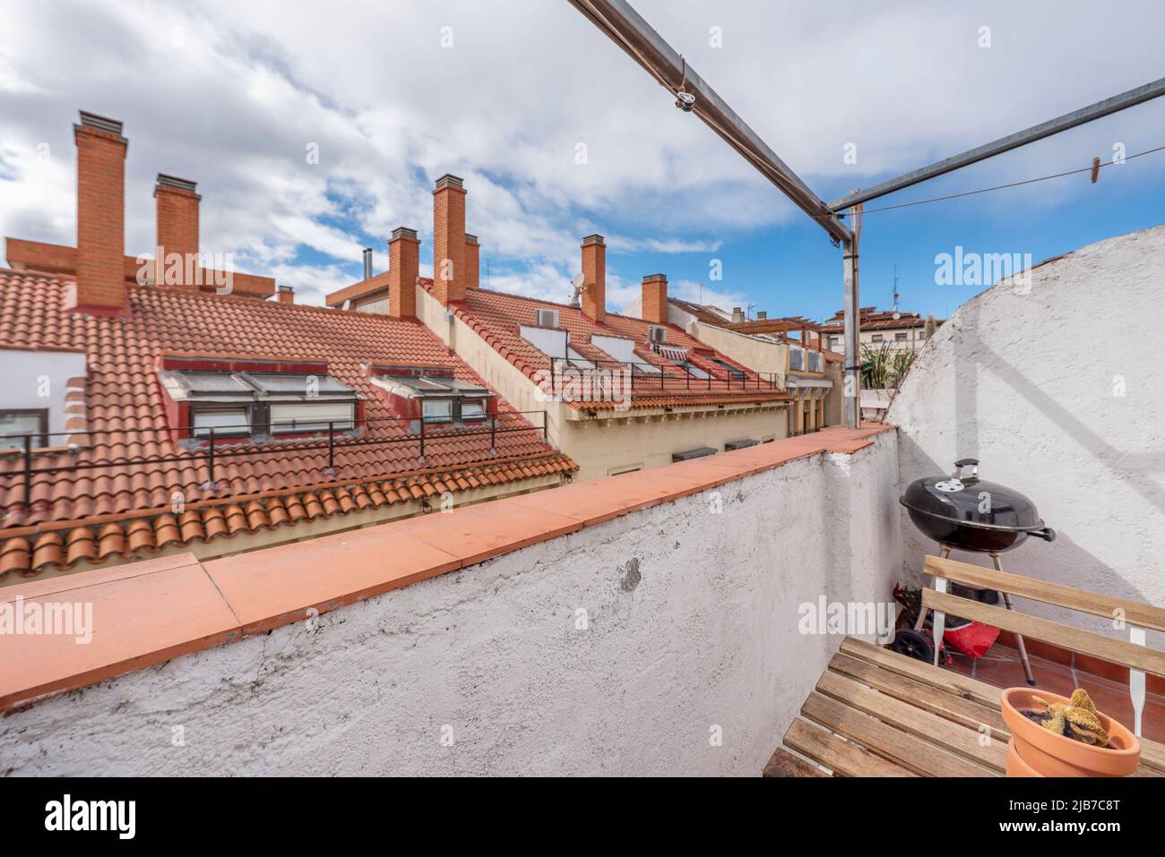 Terrace of a house with charcoal barbecue and views of the roofs with ...