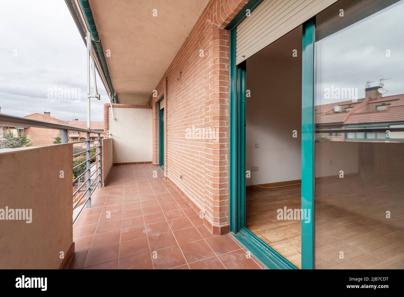 long terrace of a house with green aluminum and glass sliding windows ...