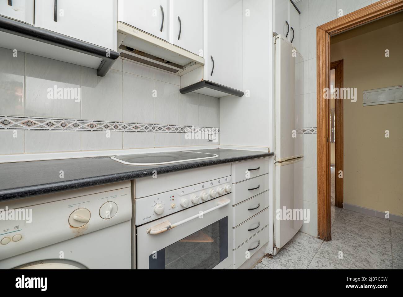 Apartment kitchen with white cabinets with matching drawers and doors ...