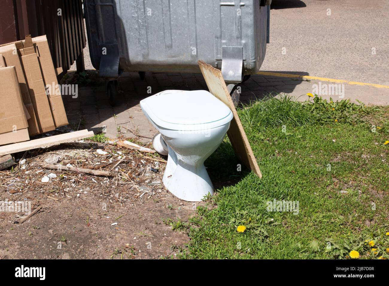 A white ceramic toilet bowl discarded in landfill close up Stock Photo ...