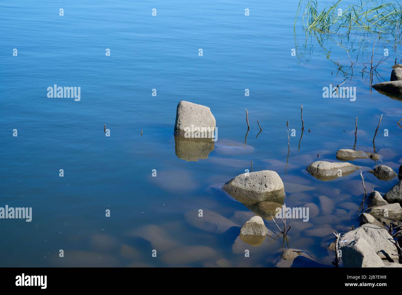 Large cobblestones on the lake and water. Clear water. Close-up Stock ...