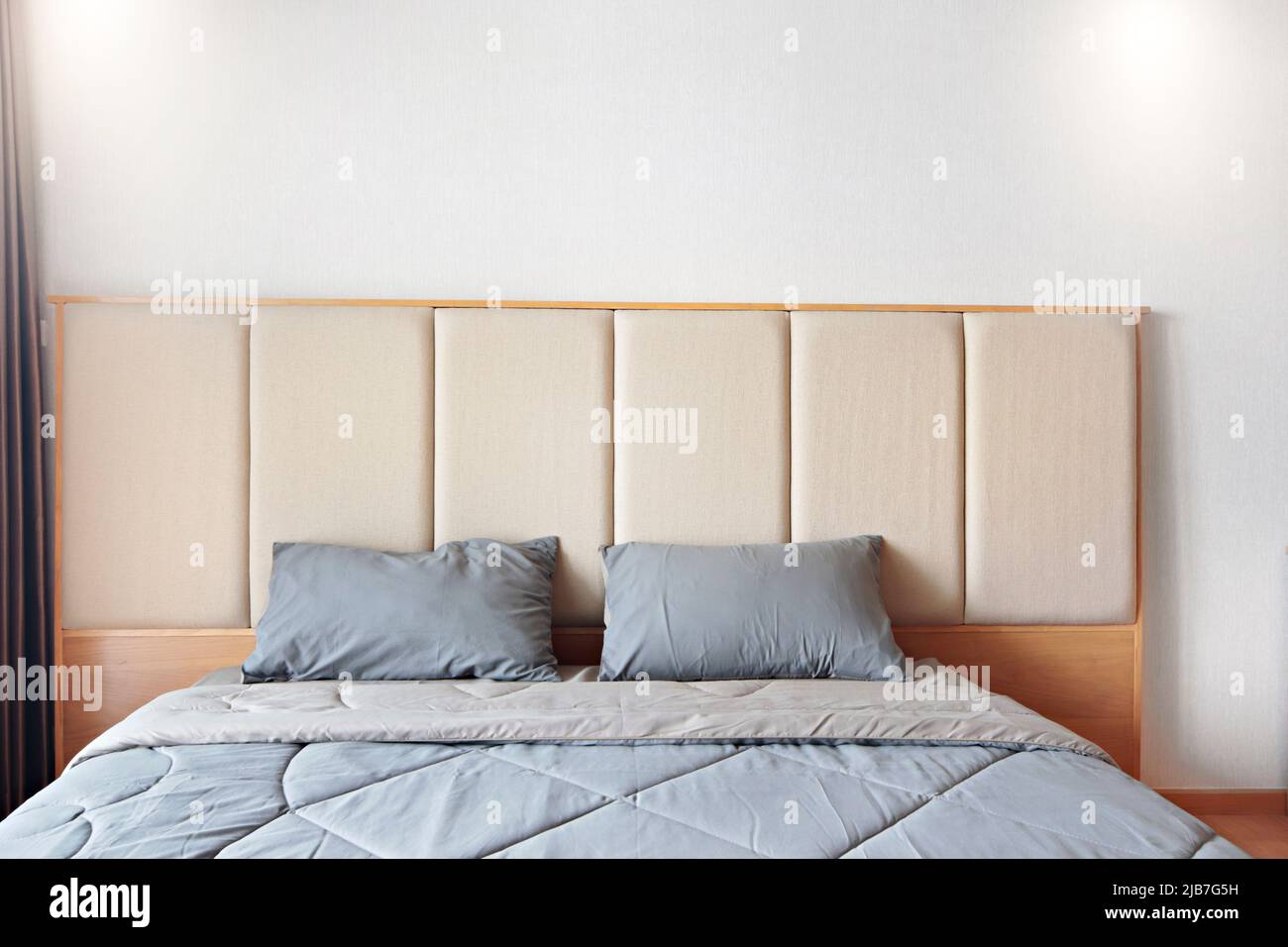 Many soft pillows on comfortable bed indoors Stock Photo - Alamy