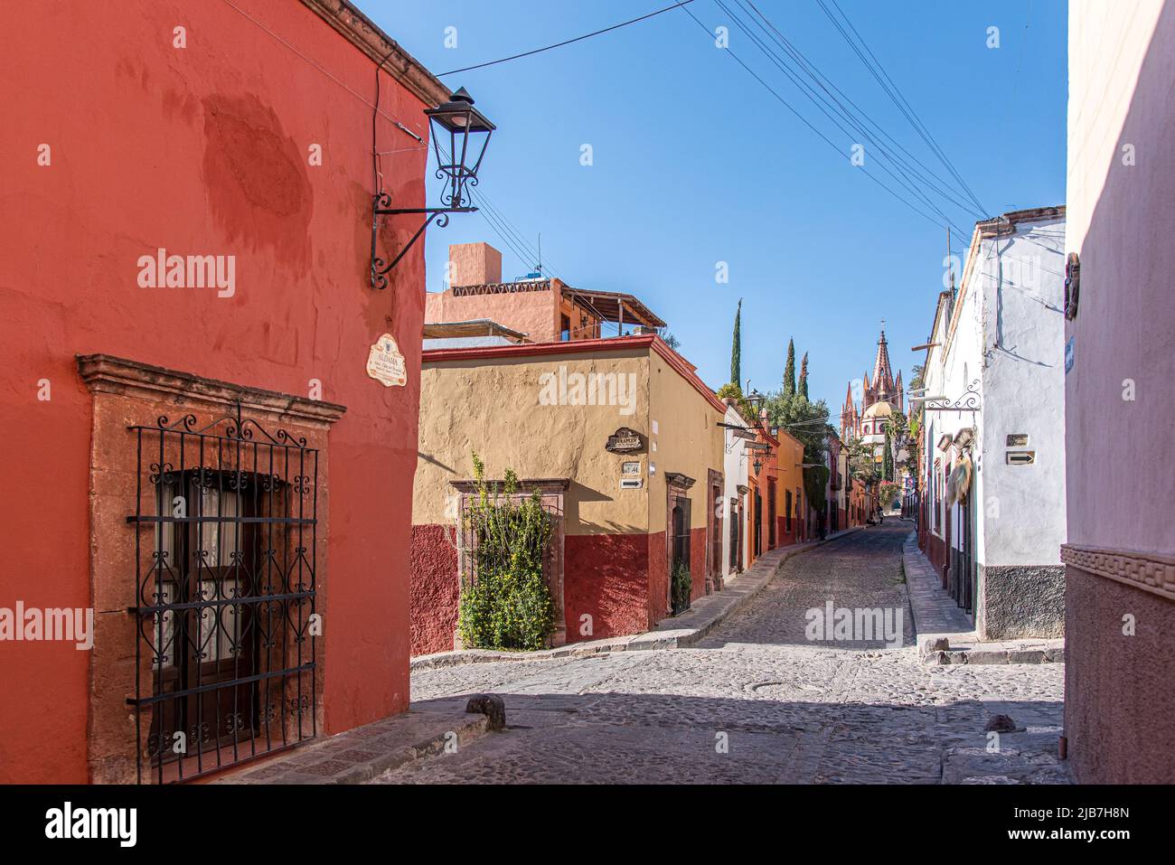 An intersection of cobblestone streets surrounded by colorful buildings ...