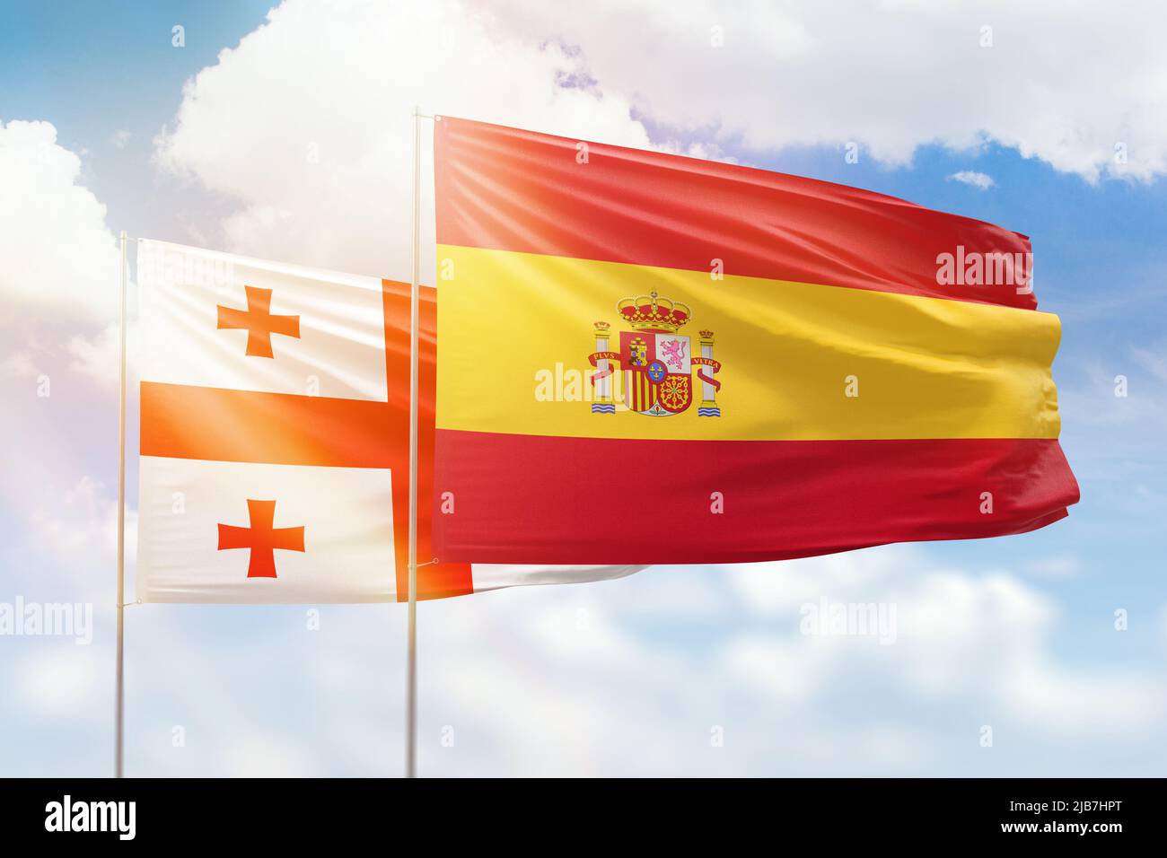 Sunny blue sky and flags of spain and georgia Stock Photo - Alamy