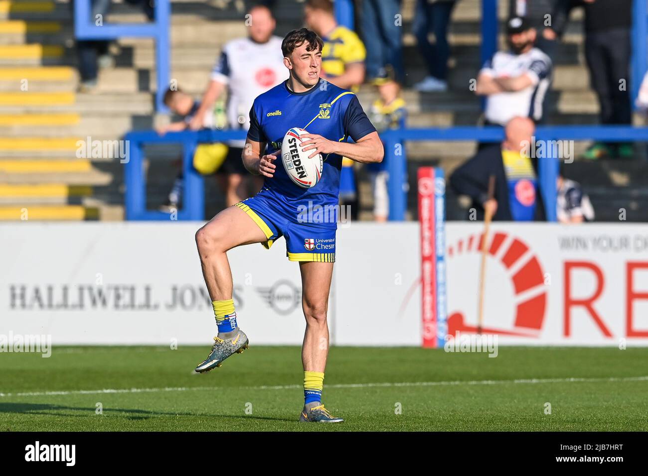 Matty Ashton #5 of Warrington Wolves stretches during pre match warm up ...