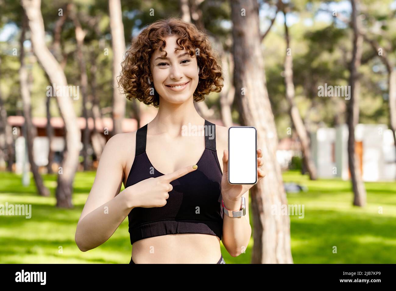 Cute Caucasian Woman Wearing Green T Shirt Standing On City Park