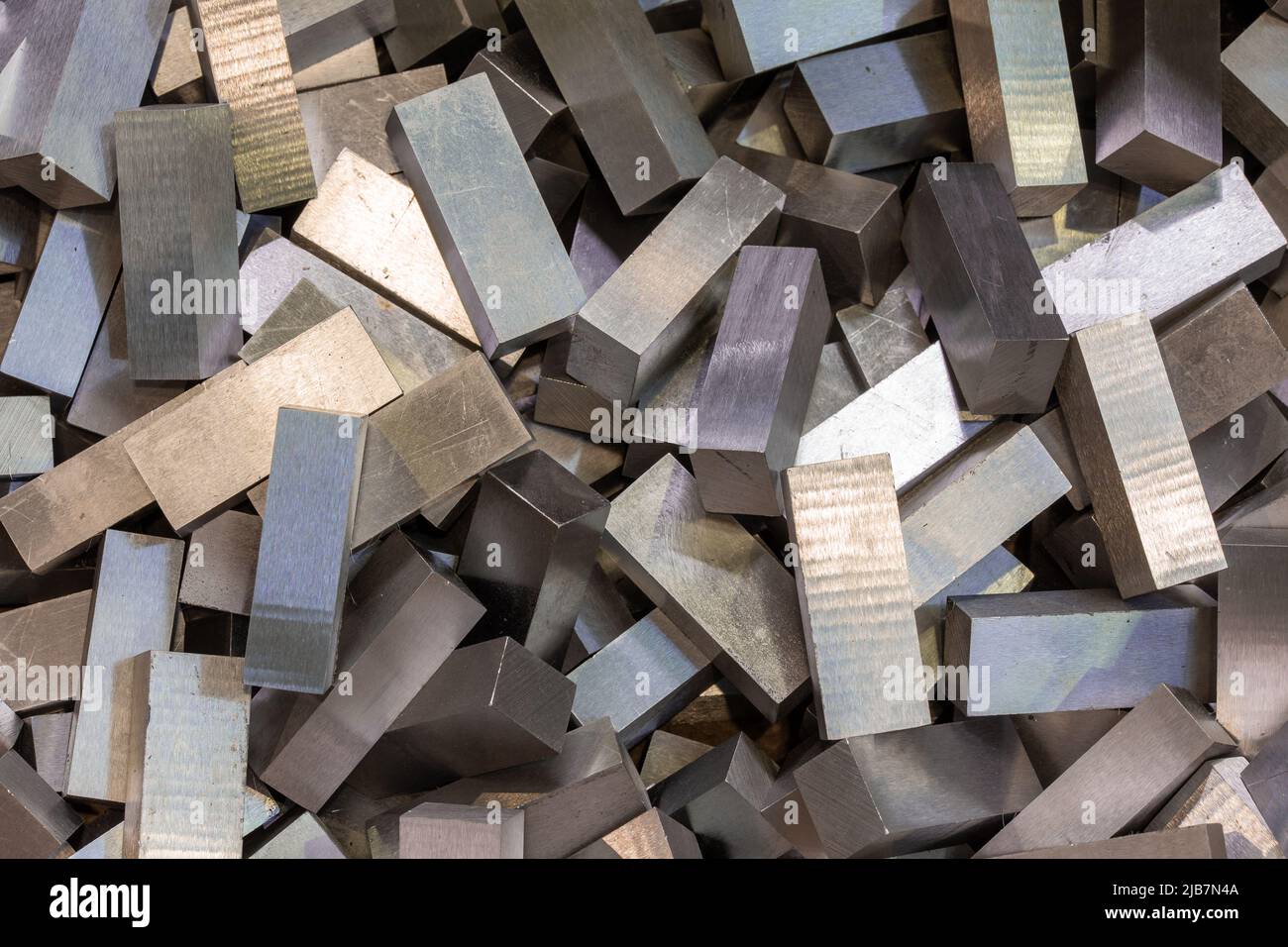 pile of cuboid steel workpieces after surface grinding Stock Photo - Alamy