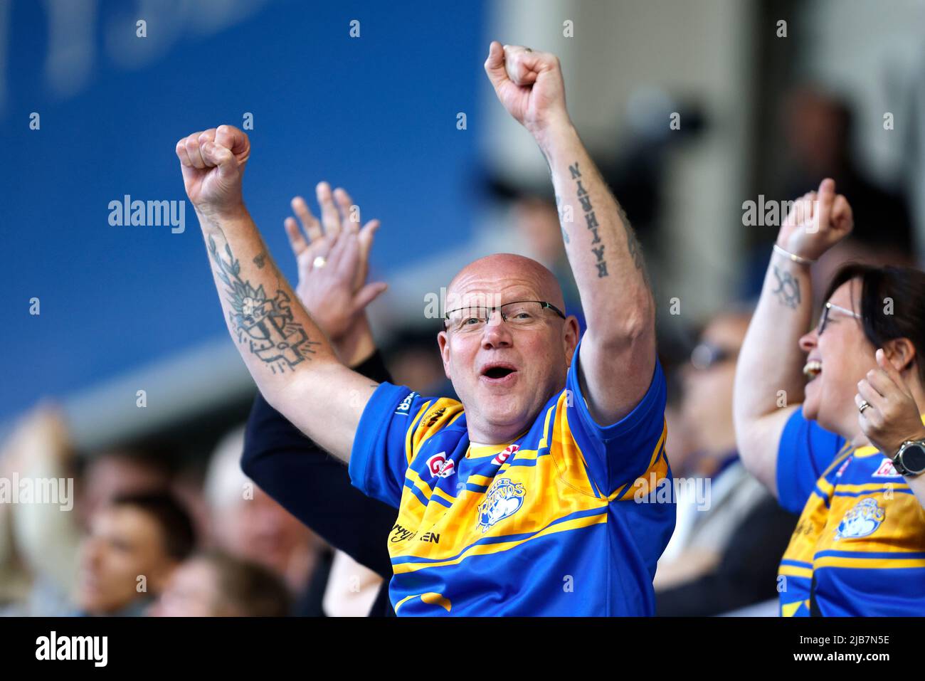 Leeds Rhinos fans celebrate their side's fourth try of the game, scored ...