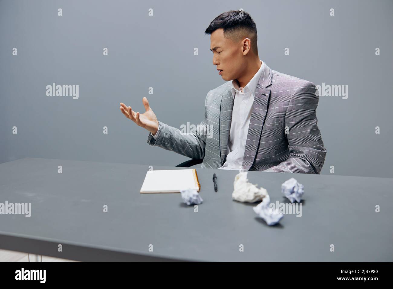 worker in a gray suit crumpled paper office official emotions isolated ...