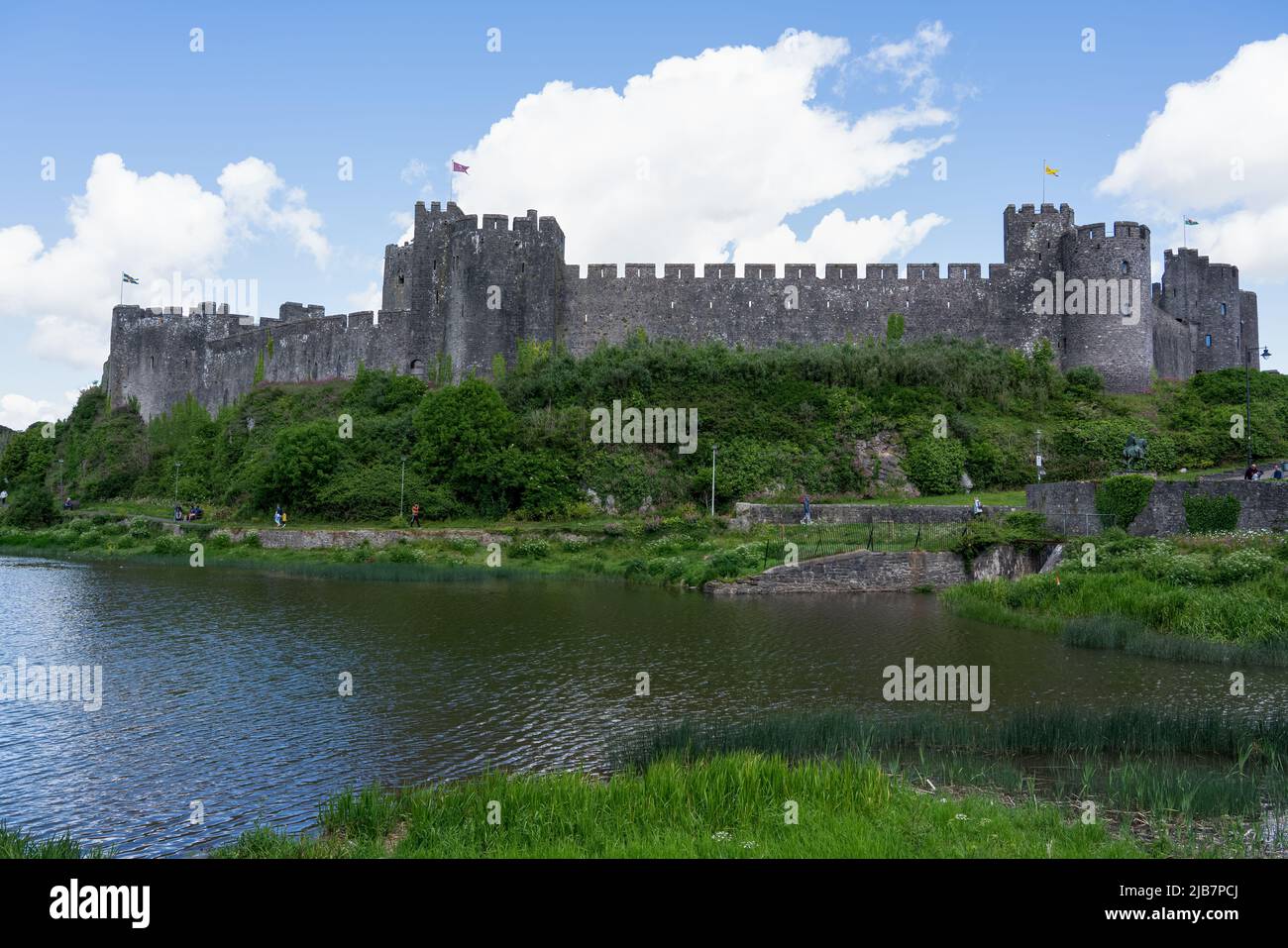 view of Pembroke Castle over Pembroke River waterway, blue sky Stock ...