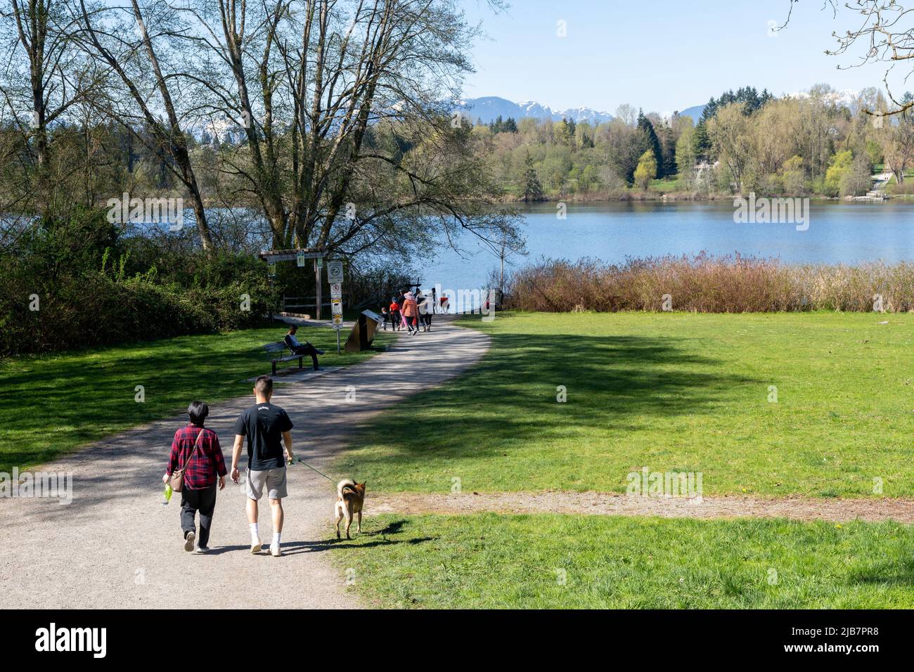 Burnaby, BC, Canada - April 18 2021 : People walking on the Deer Lake ...