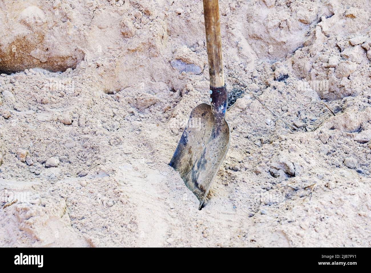 a pile of yellow river sand with a shovel on a construction site Stock ...
