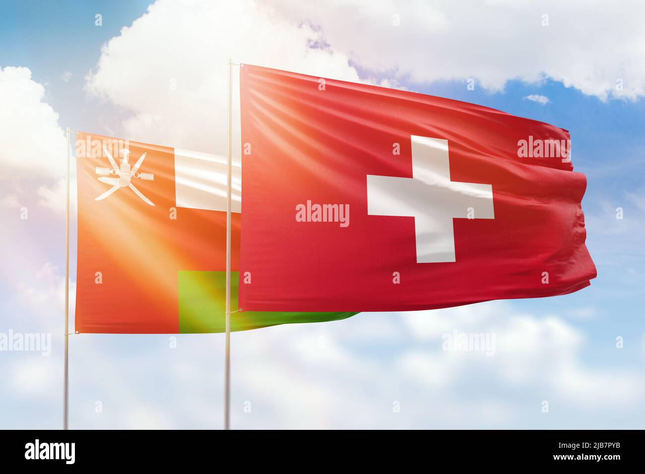 Sunny blue sky and flags of switzerland and oman Stock Photo - Alamy
