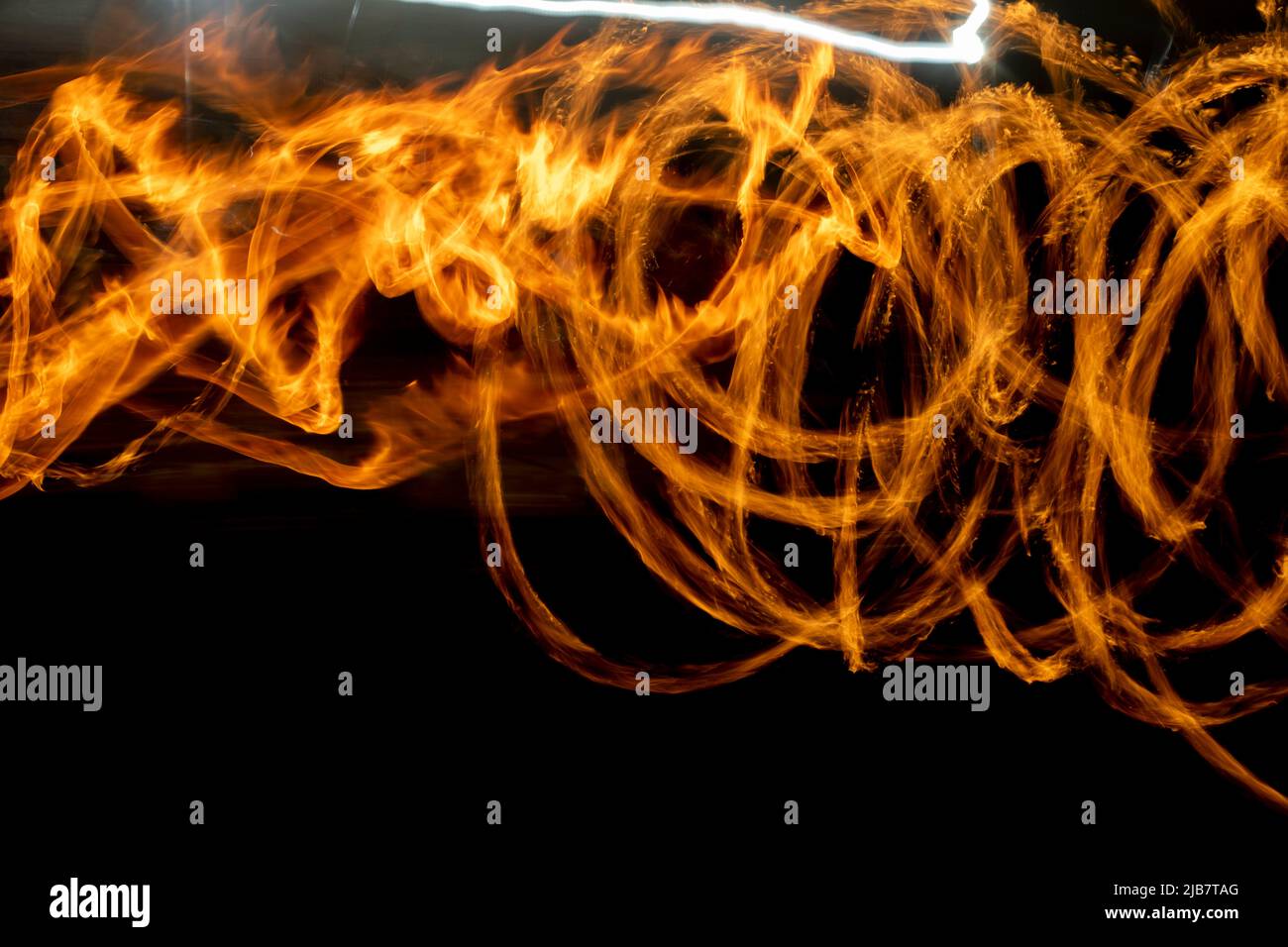 Circles of fire. Lines of flame. Shooting fire show on long shutter ...