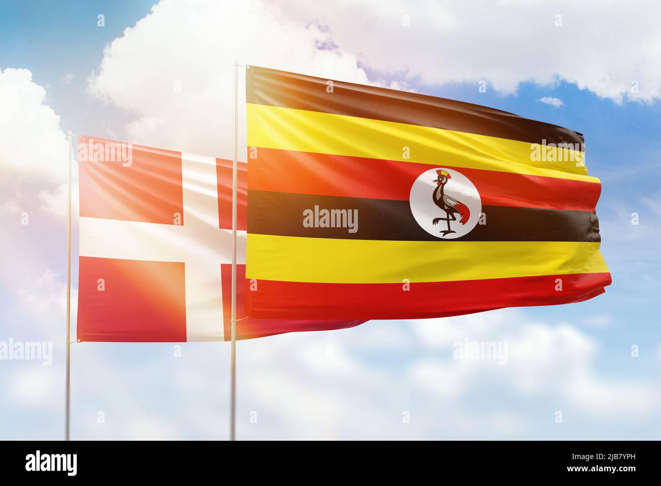 Sunny blue sky and flags of uganda and denmark Stock Photo - Alamy