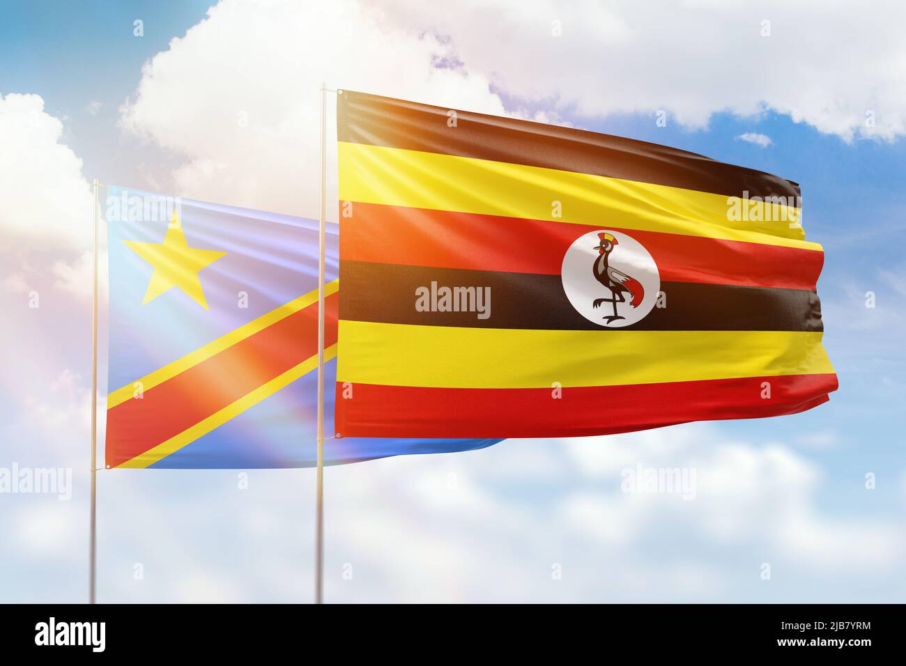 Sunny blue sky and flags of uganda and dr congo Stock Photo - Alamy