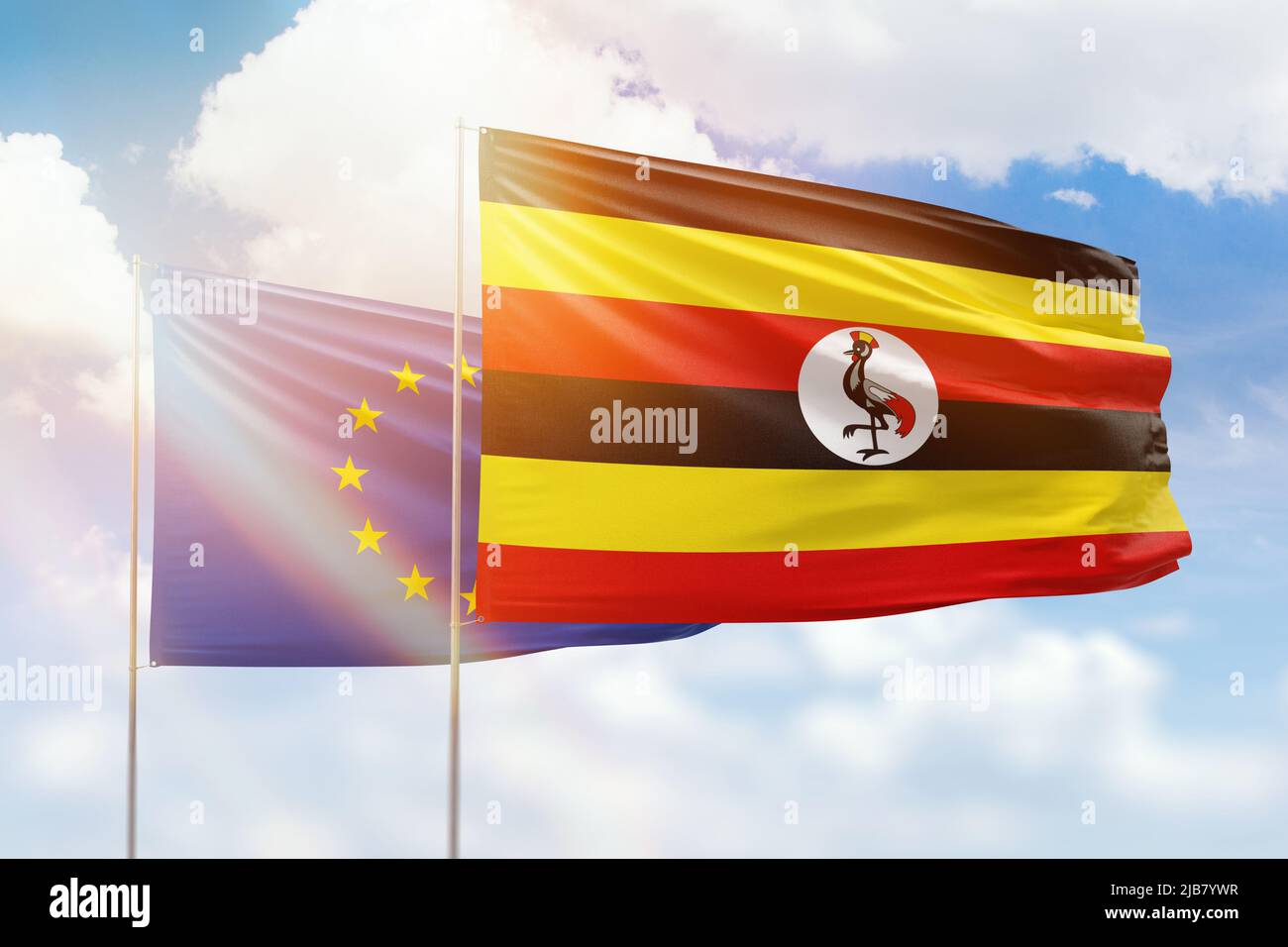 Sunny blue sky and flags of uganda and european union Stock Photo - Alamy