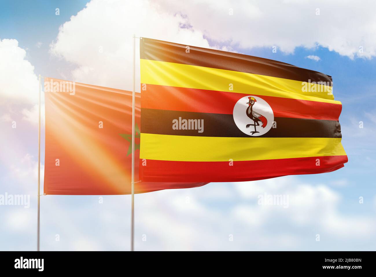 Sunny blue sky and flags of uganda and morocco Stock Photo - Alamy