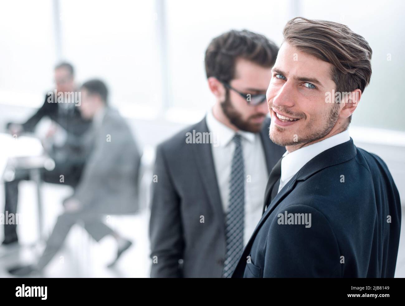 young businessman standing in a modern office Stock Photo - Alamy