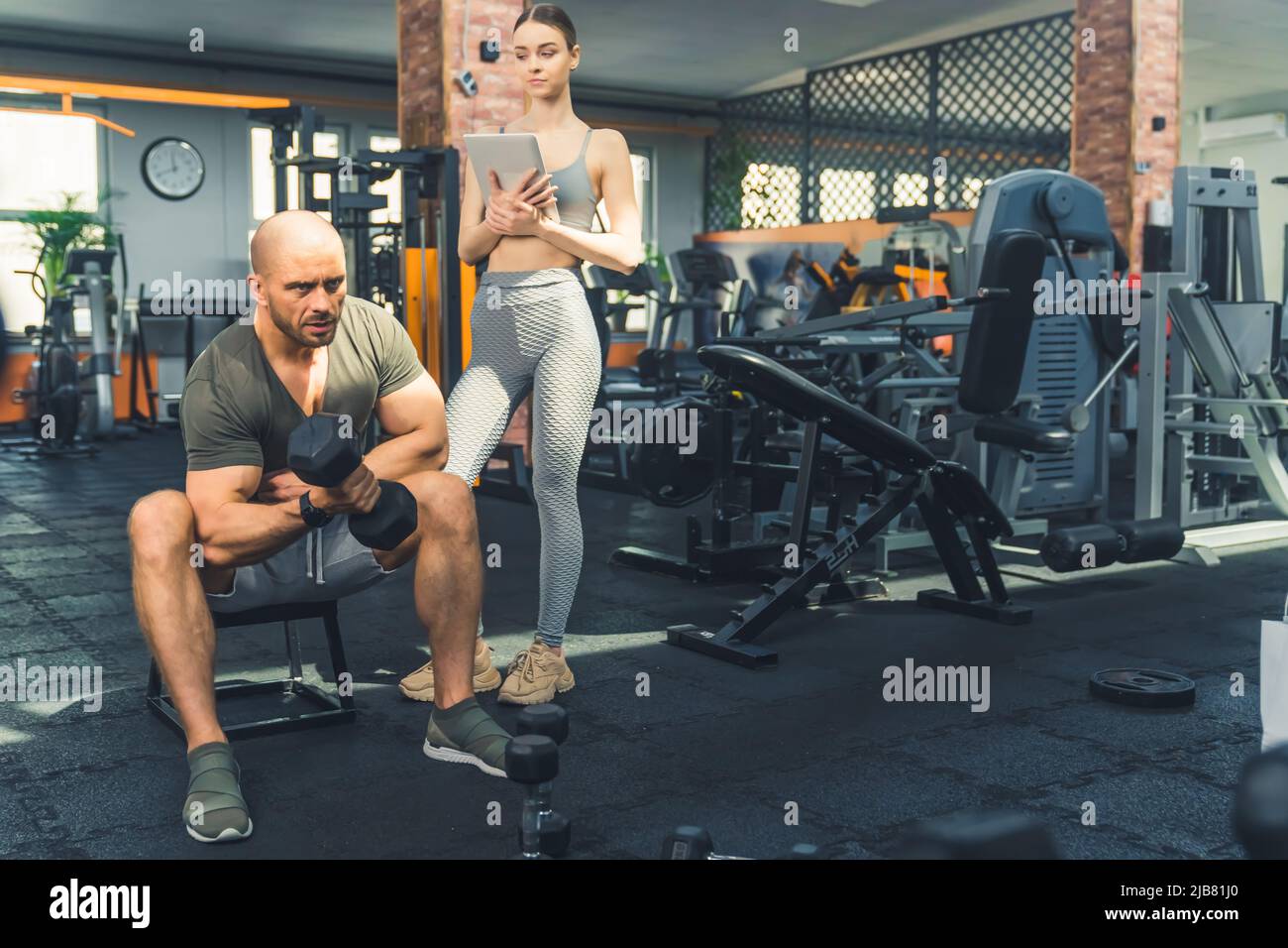Working on his arms. full-length shot of a muscular young man working ...