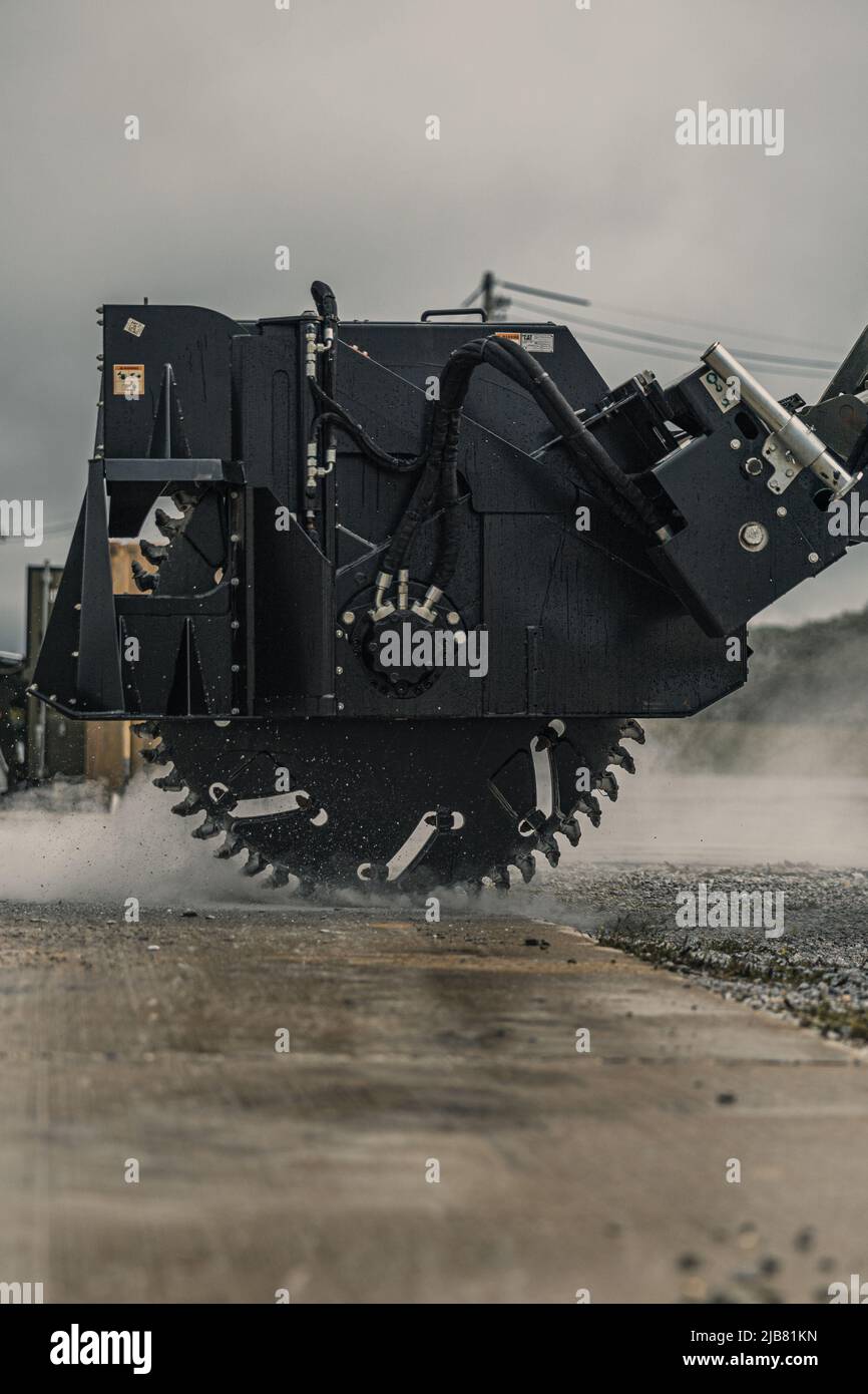 U.S. Sailors with Naval Mobile Construction Battalion 3 operate a skid ...
