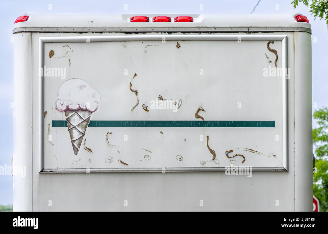 back of an Ice cream delivery truck with a picture of an ice cream cone ...