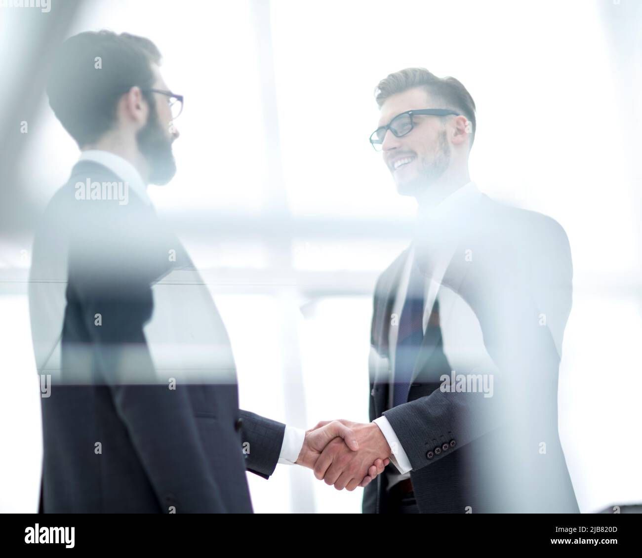 handshake is serious business partners Stock Photo - Alamy
