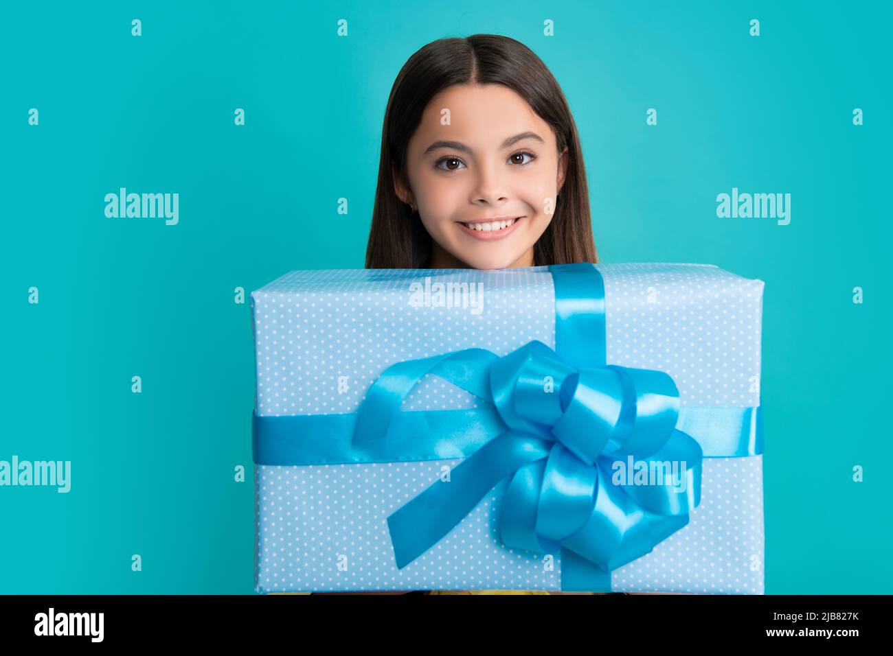 Happy girl face, positive and smiling emotions. Child with gift present ...