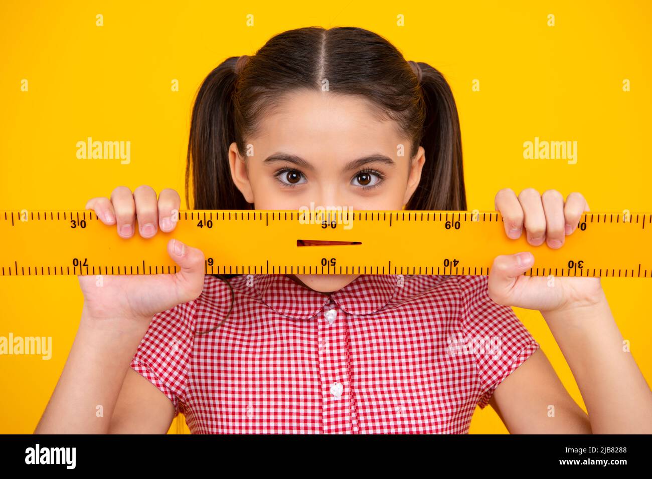 Teenager school girl study math or geometry lesson, measure the size ...