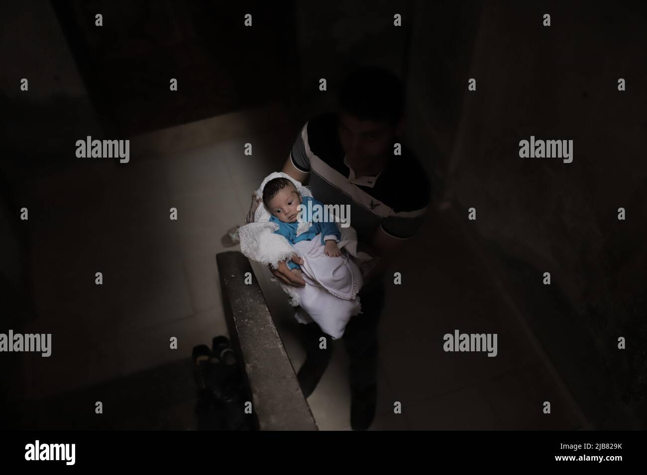 A father carrying his baby from Gaza Stock Photo - Alamy