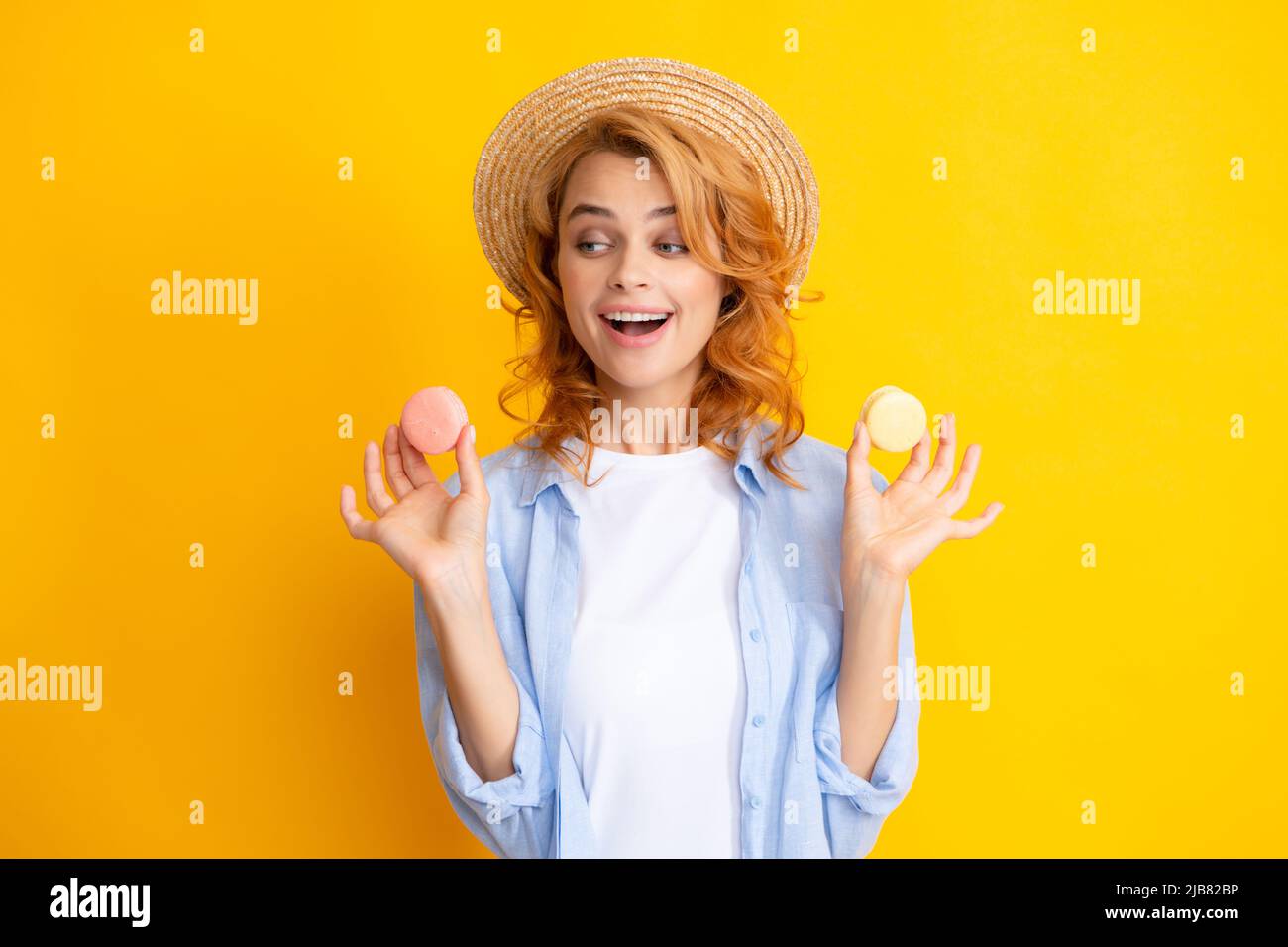Beauty model girl taking colorful macaroons. Beautiful woman eating ...