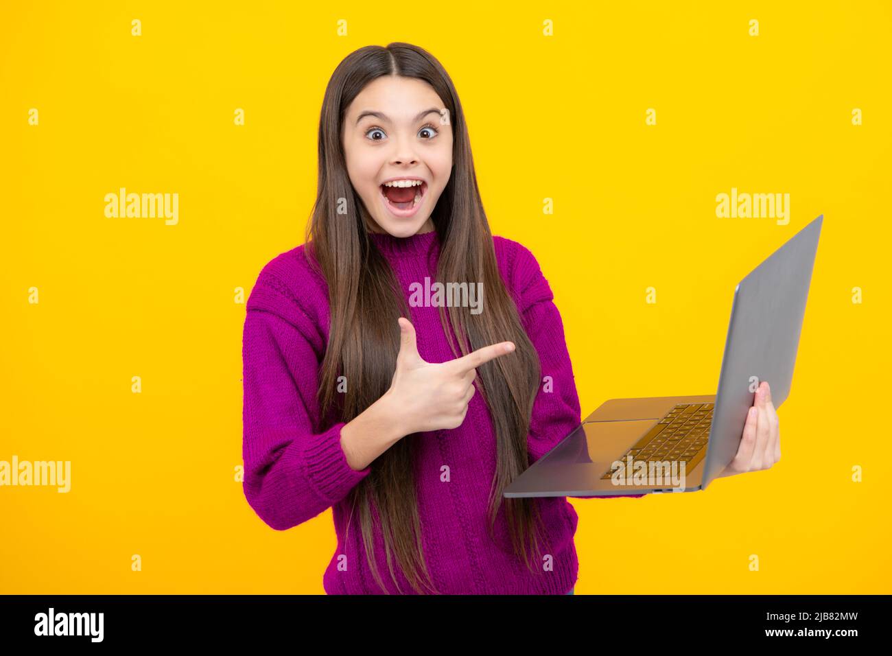 Excited face. Student school girl with laptop on isolated studio ...