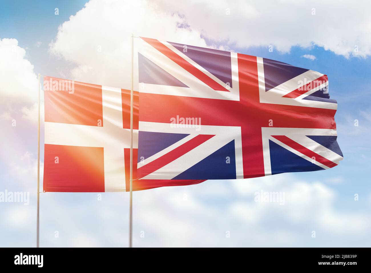 Sunny blue sky and flags of united kingdom and denmark Stock Photo - Alamy