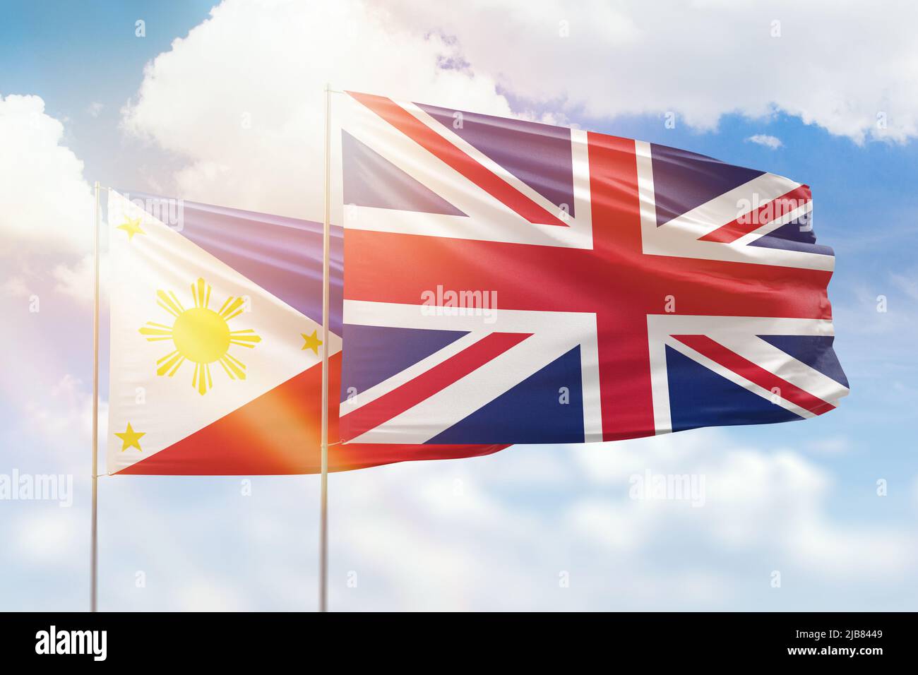 Sunny blue sky and flags of united kingdom and philippines Stock Photo ...