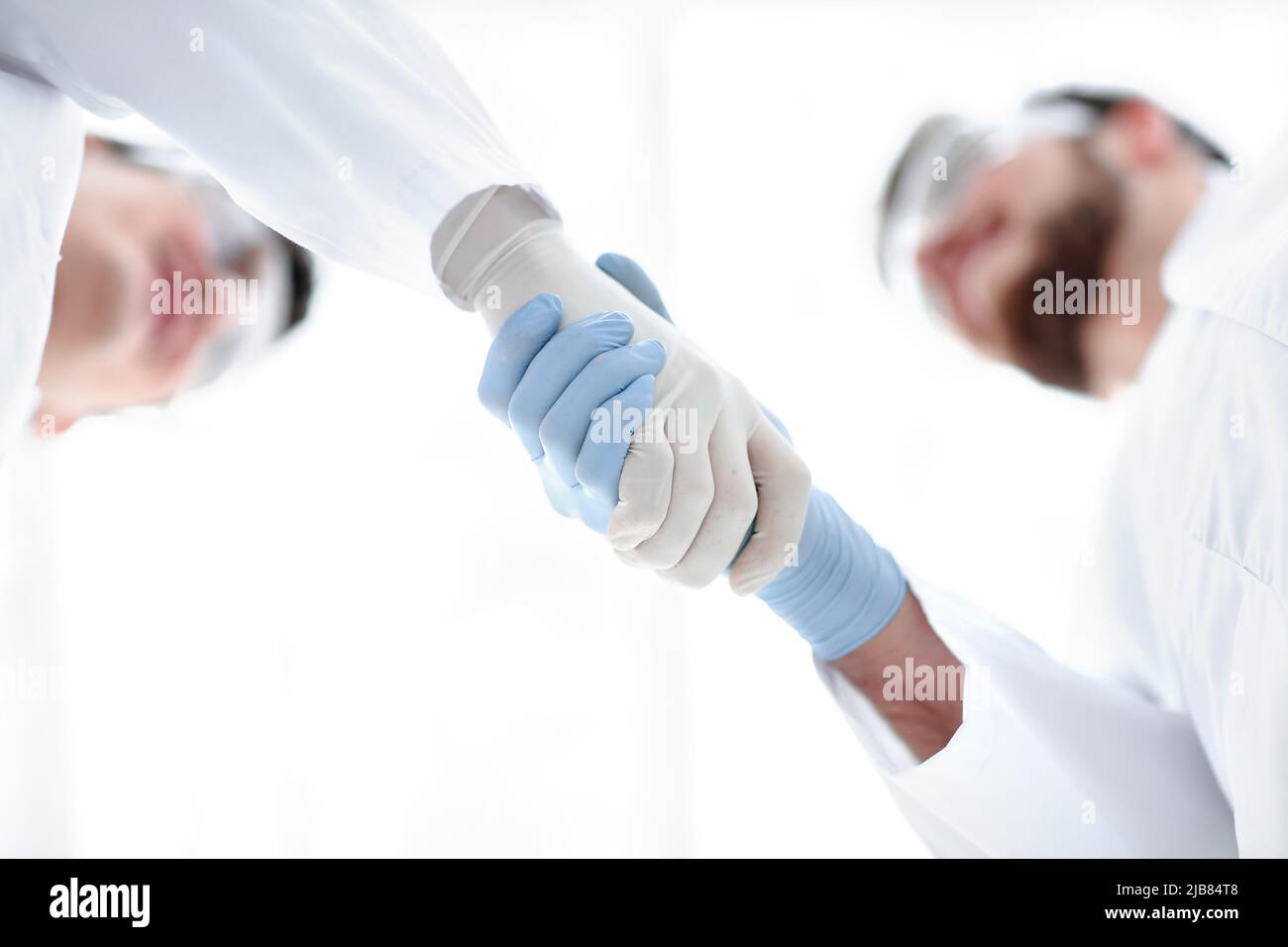 closeup.two scientists shake hands Stock Photo - Alamy