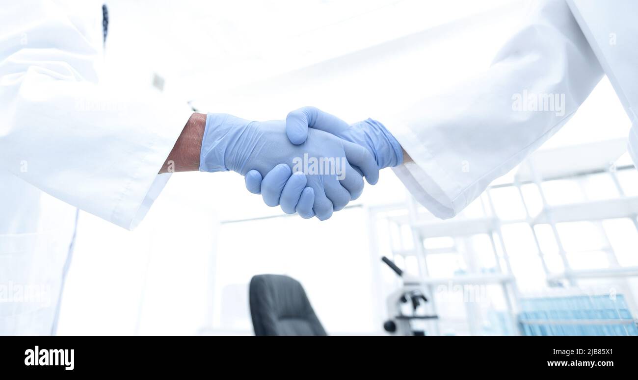 hand in the medical glove (handshake Stock Photo - Alamy