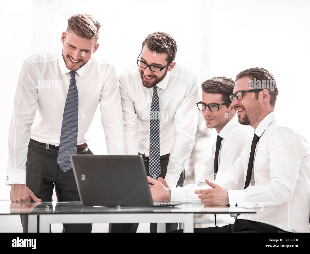 business team looks at the laptop screen Stock Photo - Alamy
