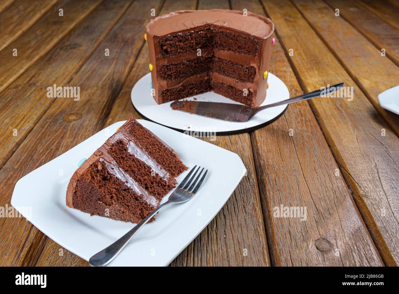 Slice of chocolate cake with filling and semisweet chocolate ganache ...