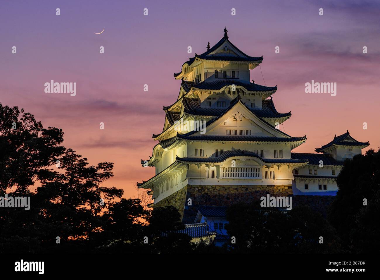 Crescent moon and sunset colors over Himeji Castle Stock Photo - Alamy