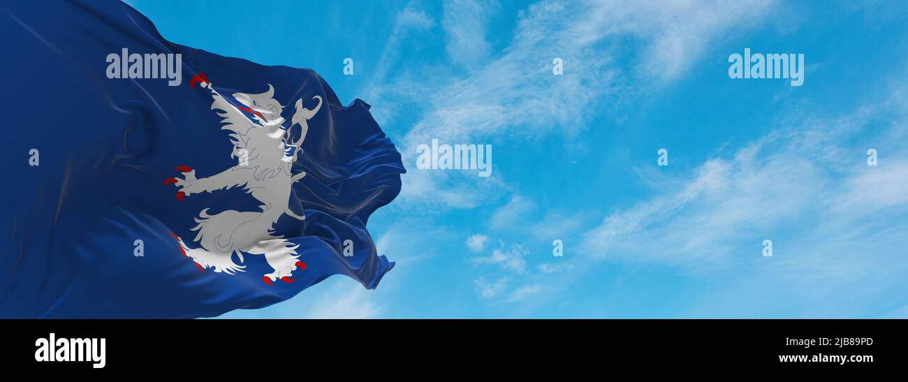 official flag of Hallands , Sweden at cloudy sky background on sunset ...